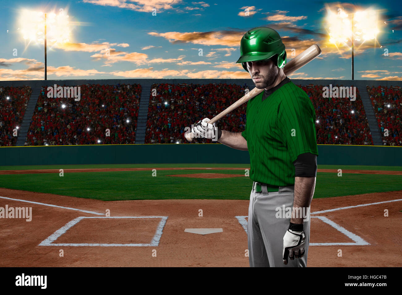 Baseball Player with a green uniform on baseball Stadium Stock Photo ...