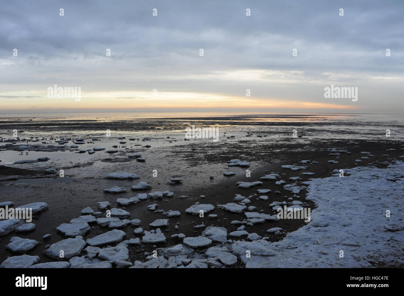 Land-fast sea ice with marginal blocks on sand expanse, south to grey ...
