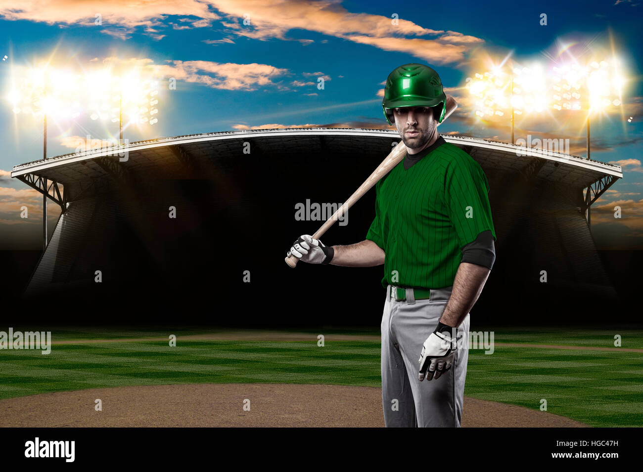 Baseball Player with a green uniform on baseball Stadium Stock Photo ...