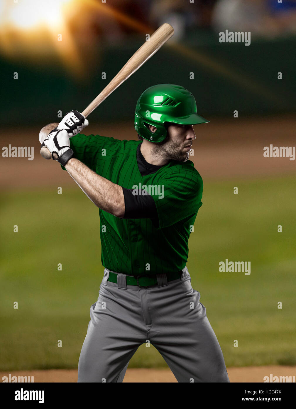 Baseball Player with a green uniform on baseball Stadium Stock Photo ...