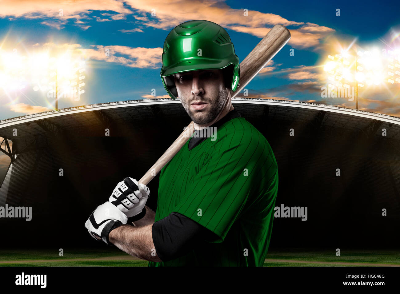Baseball Player with a green uniform on baseball Stadium Stock Photo ...