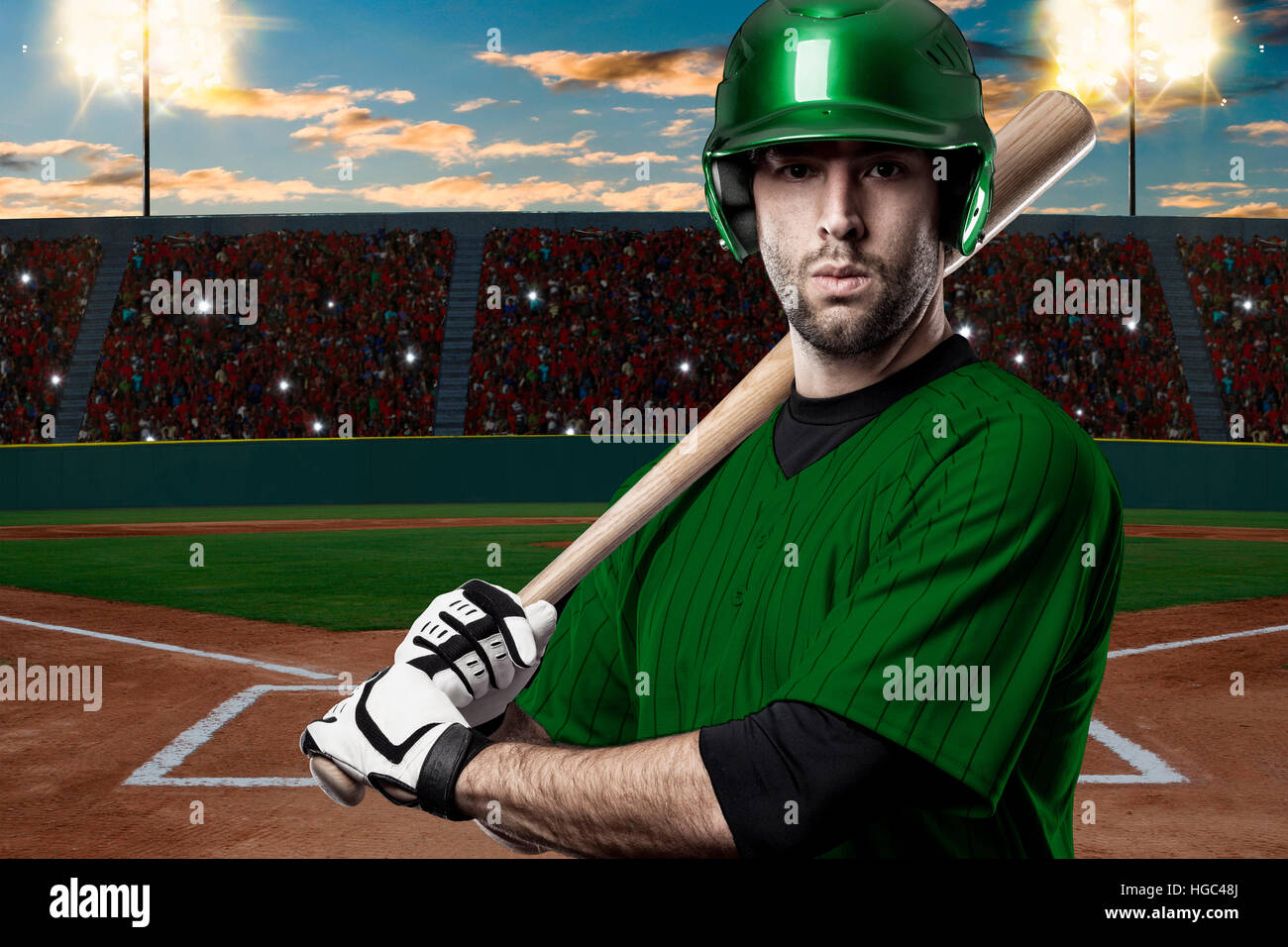 Baseball Player with a green uniform on baseball Stadium Stock Photo ...