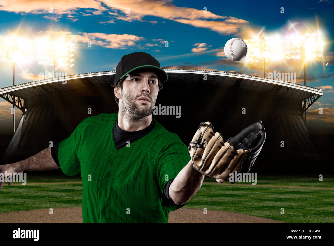 Baseball Player with a green uniform on baseball Stadium Stock Photo ...