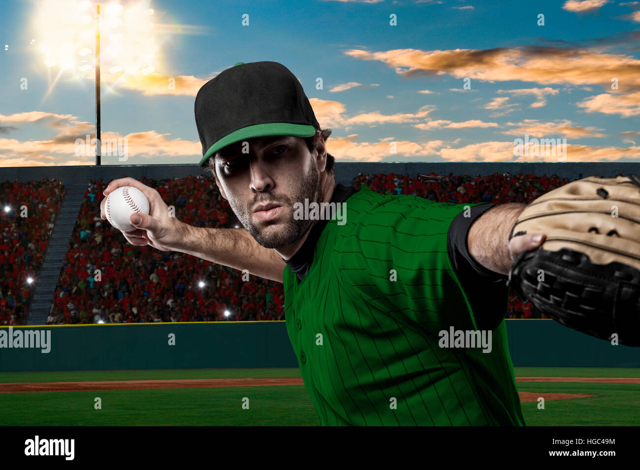 Baseball Player with a green uniform on baseball Stadium Stock Photo ...