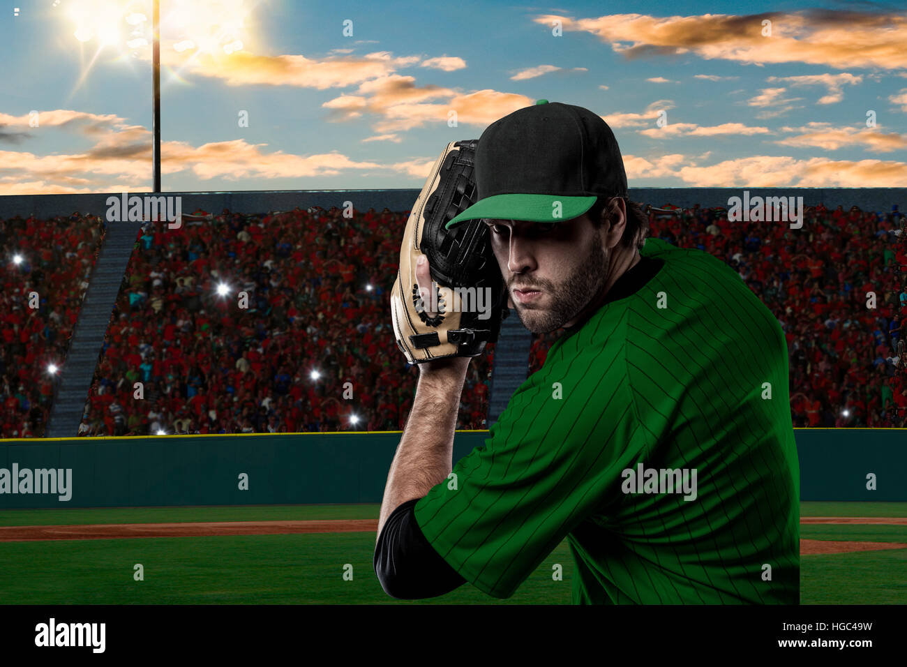 Pitcher Baseball Player with a green uniform on baseball Stadium Stock ...