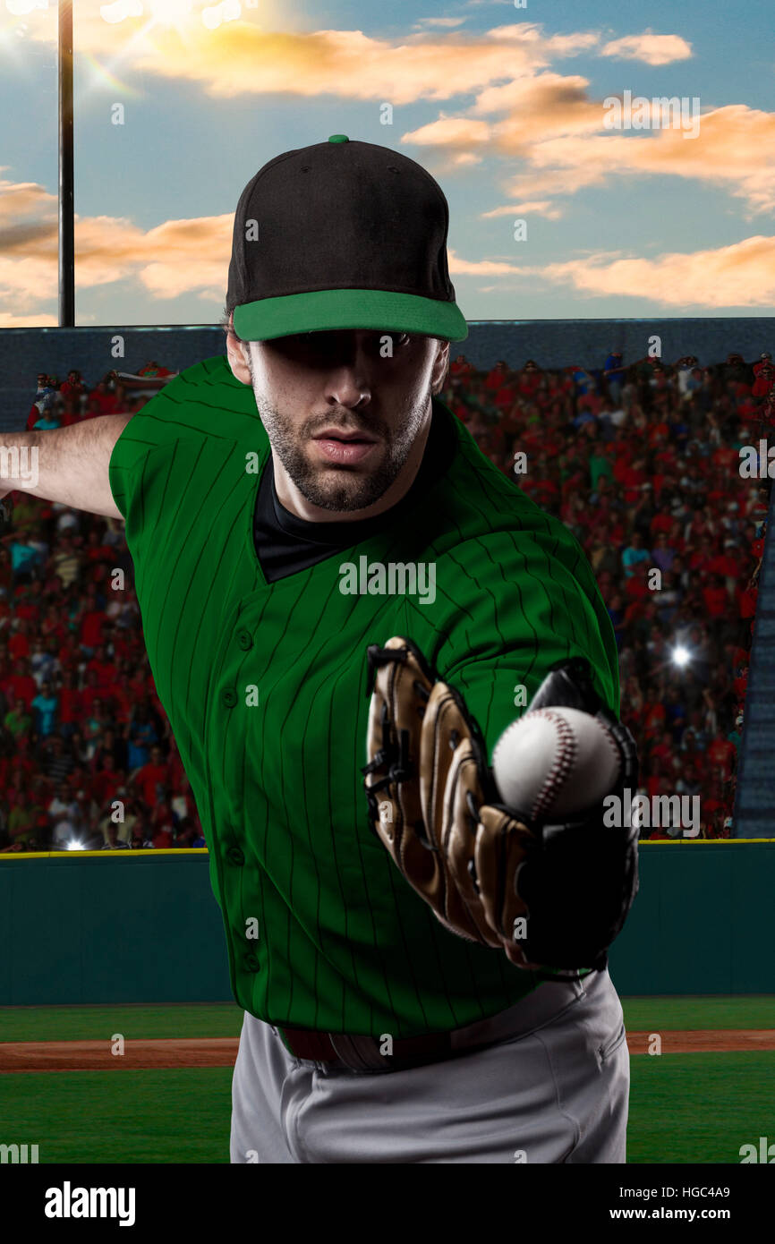 Baseball Player with a green uniform on baseball Stadium Stock Photo ...