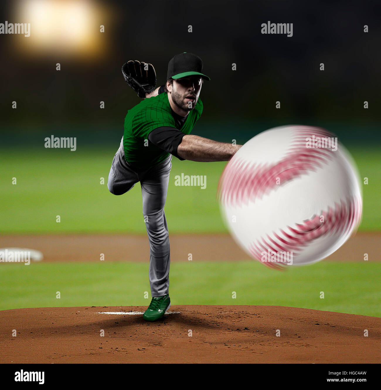 Pitcher Baseball Player with a green uniform on baseball Stadium Stock ...