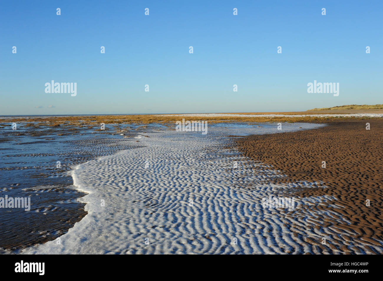 Beach wide flat sand ripples expanse foreground extending background ...
