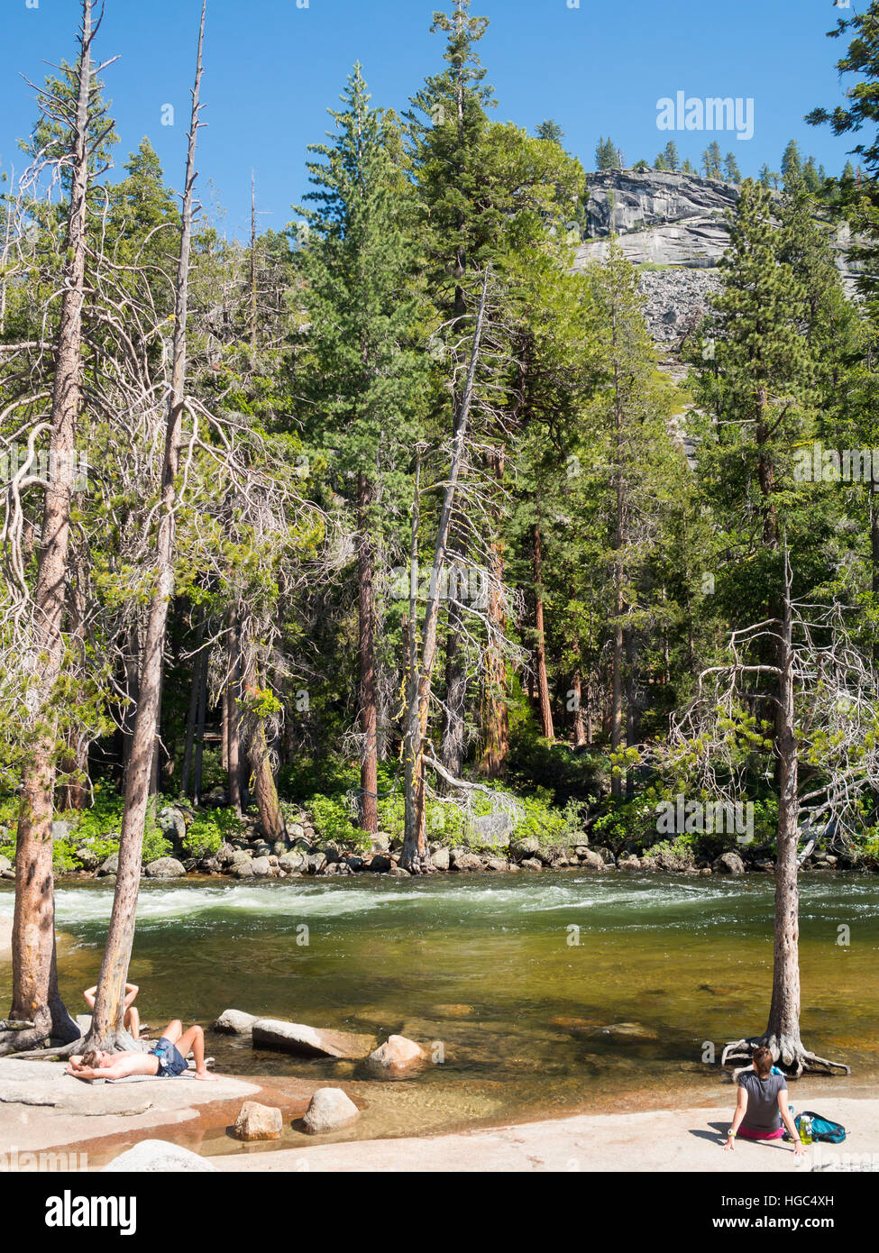 Resting by the tranquil Merced River at the top of Nevada Falls Stock ...