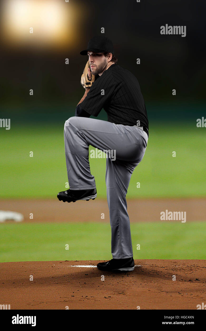 Pitcher Baseball Player with a black uniform on baseball Stadium Stock ...