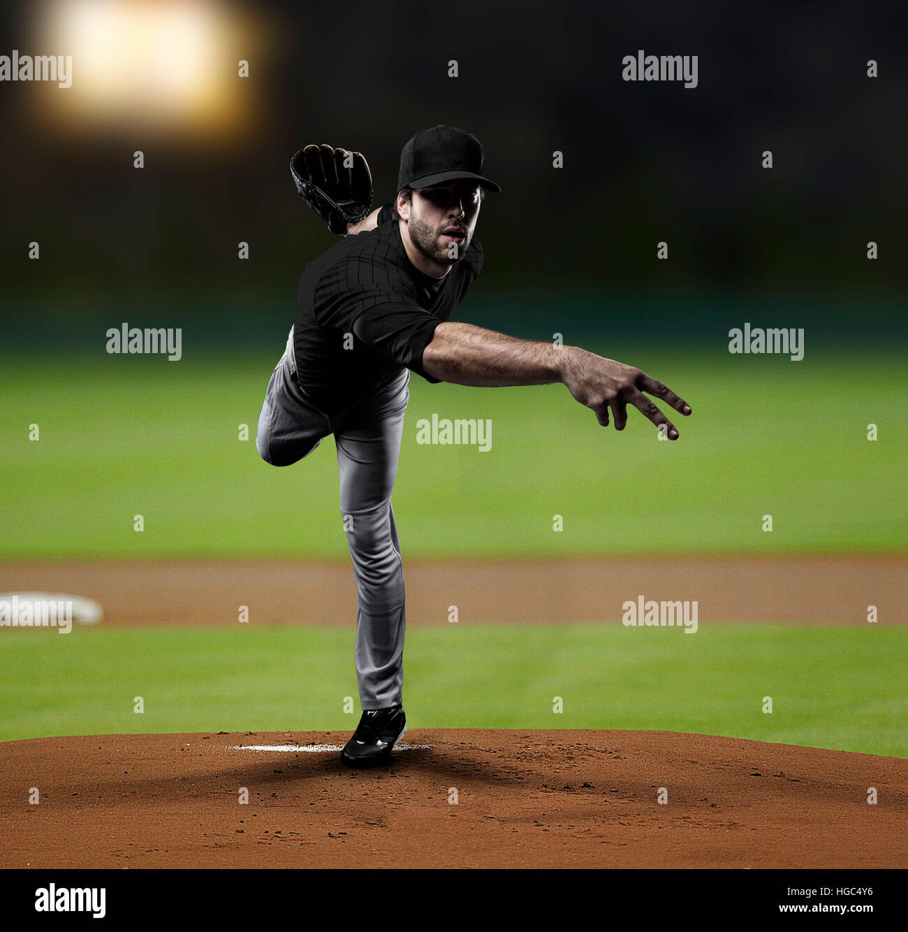 Pitcher Baseball Player with a black uniform on baseball Stadium Stock ...