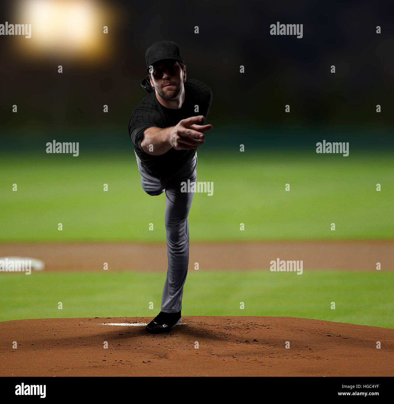 Pitcher Baseball Player with a black uniform on baseball Stadium Stock ...