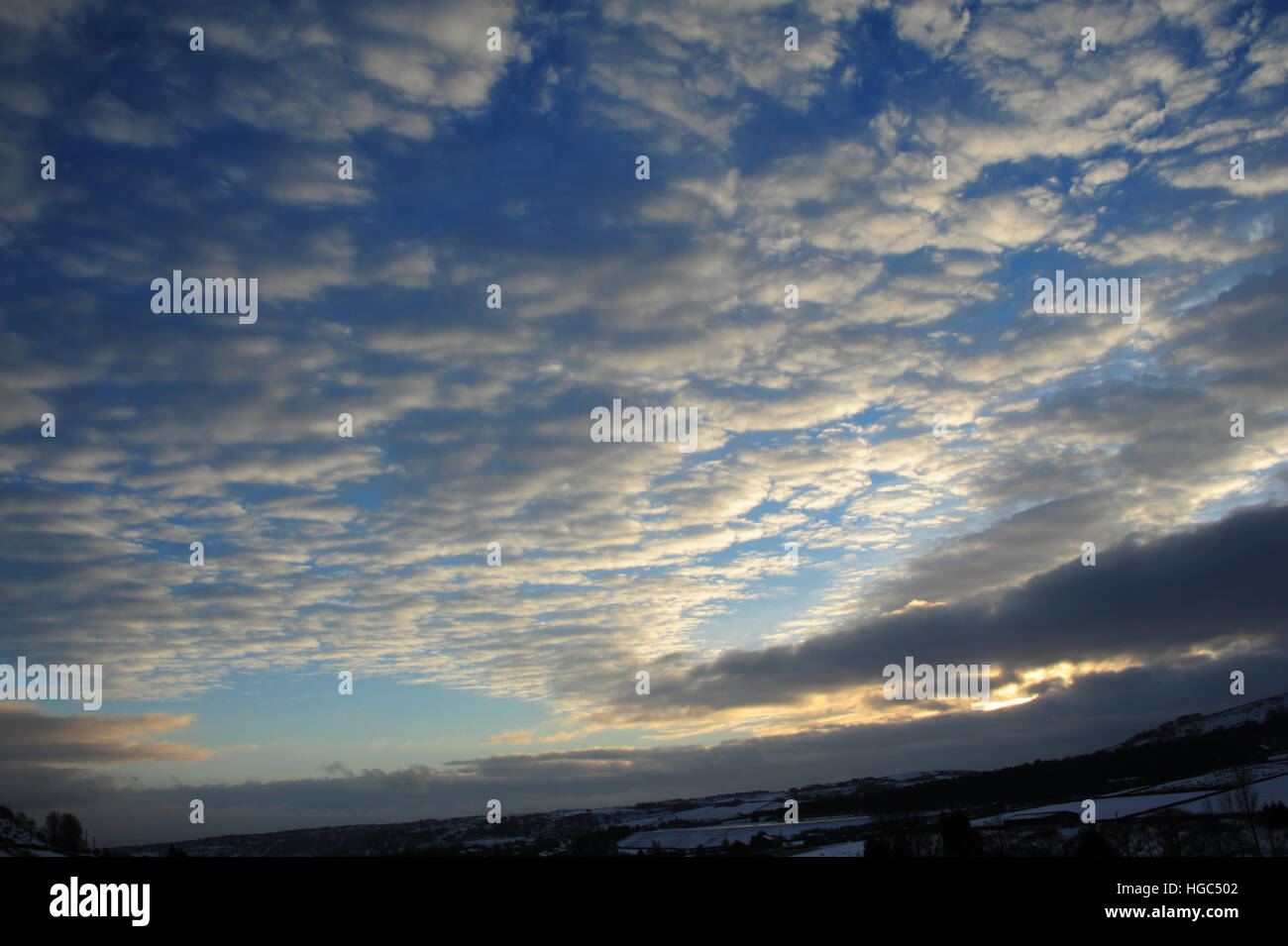 Blue sky altocumulus clouds orange sunset view snowy Hebble Valley ...