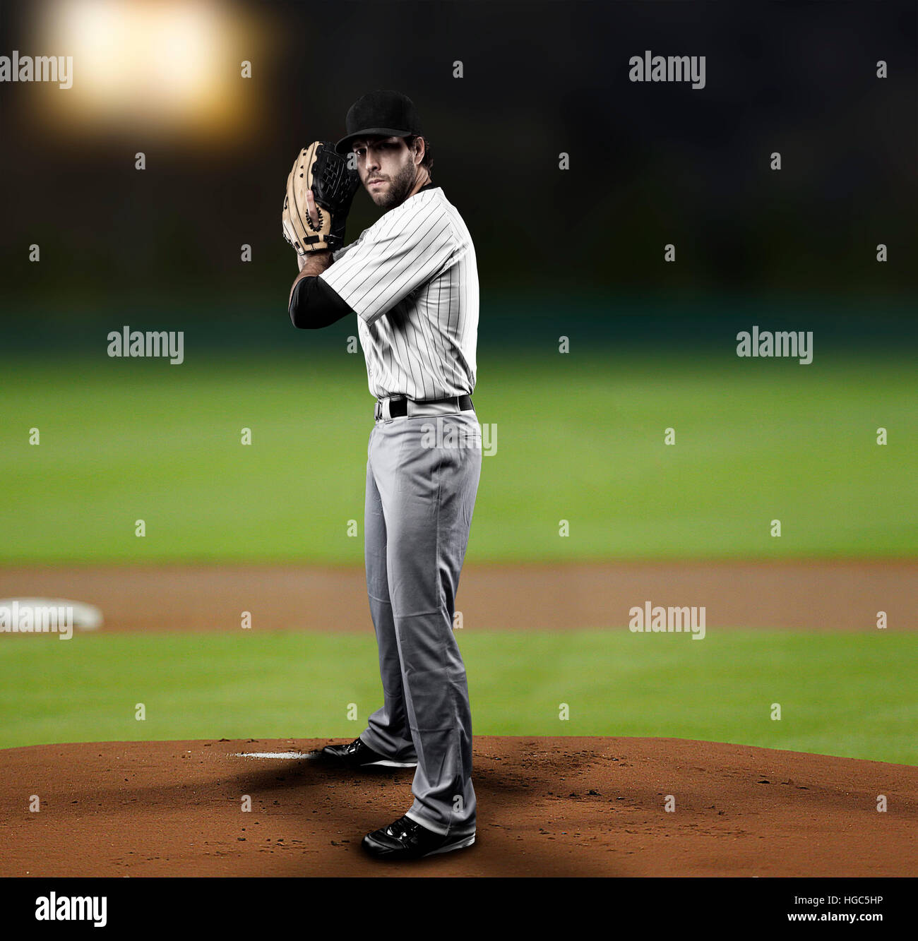 Pitcher Baseball Player with a white uniform on baseball Stadium Stock ...