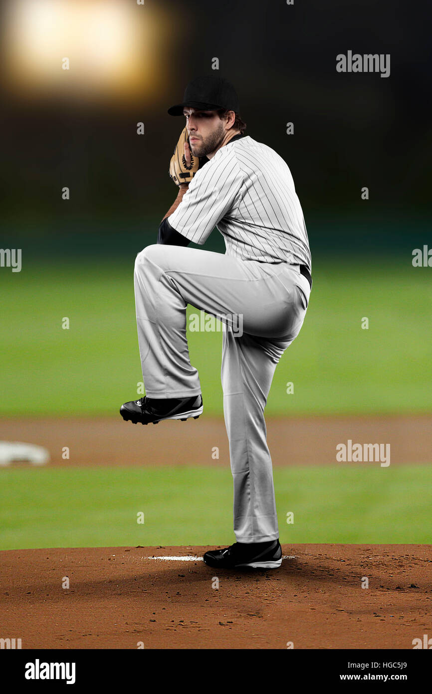 Pitcher Baseball Player with a white uniform on baseball Stadium Stock ...