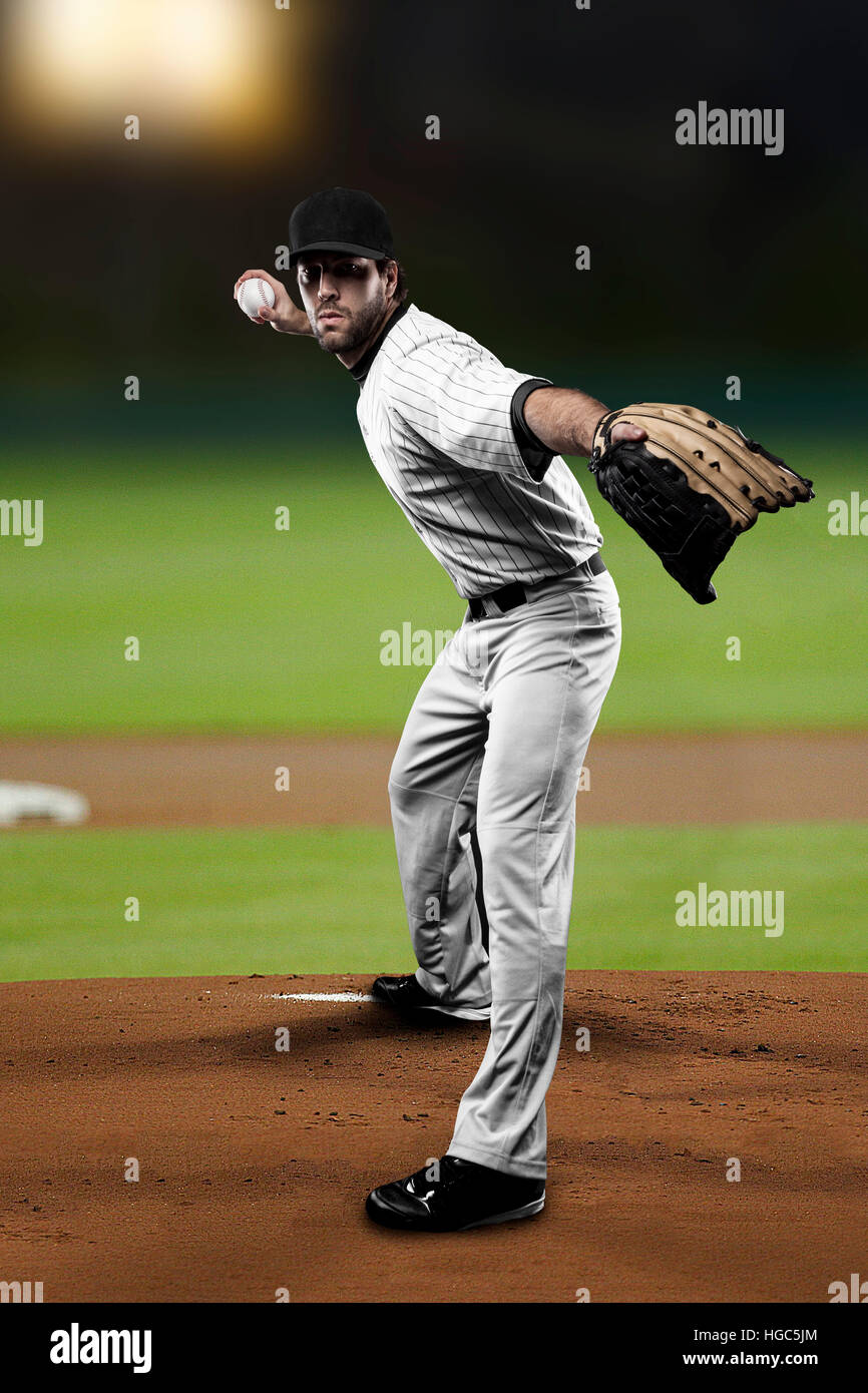 Pitcher Baseball Player with a white uniform on baseball Stadium Stock ...