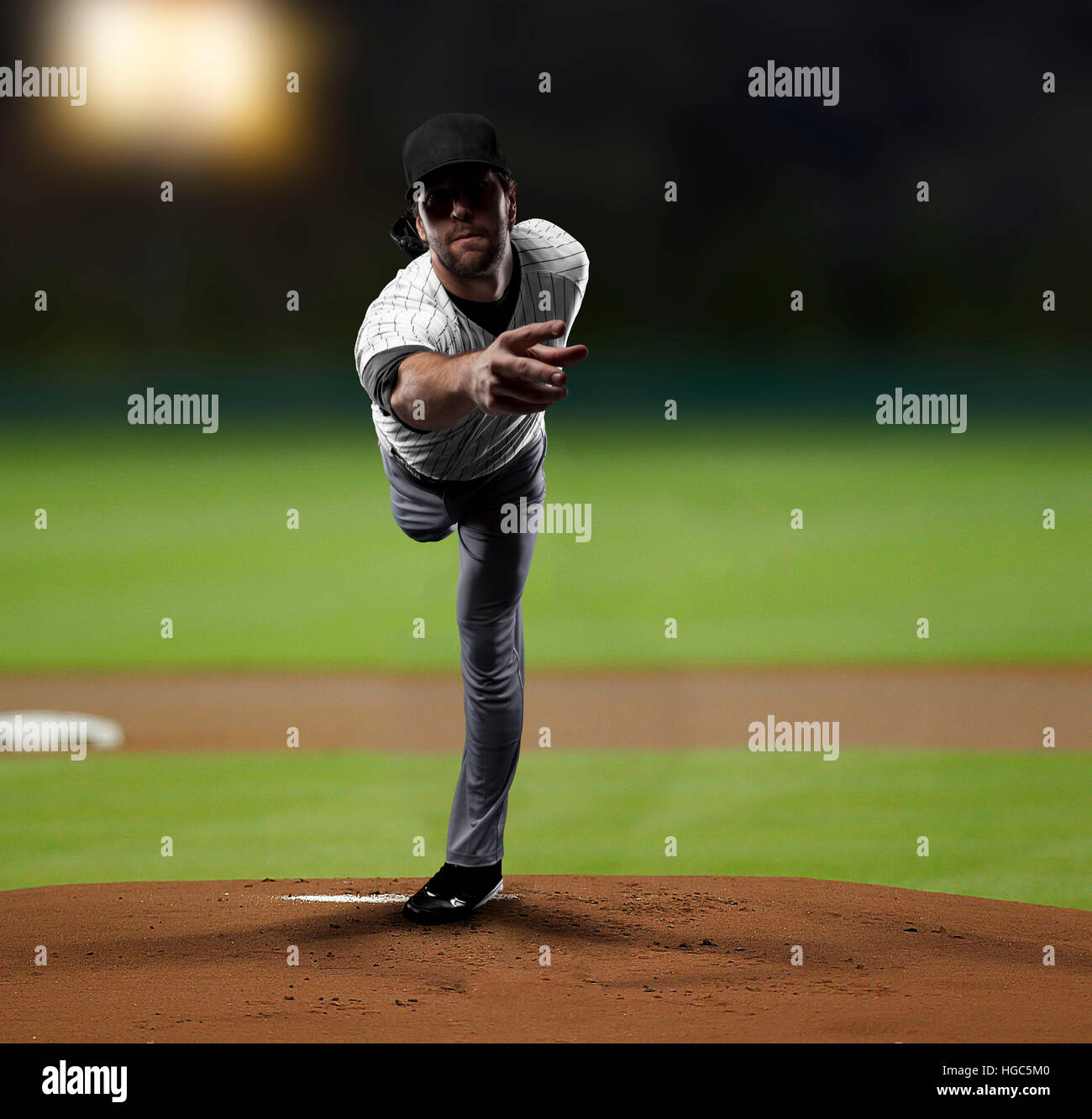Pitcher Baseball Player with a white uniform on baseball Stadium Stock ...