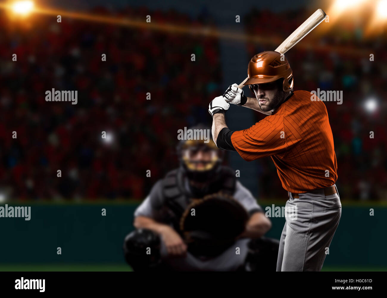 Baseball Player with a orange uniform on baseball Stadium Stock Photo ...
