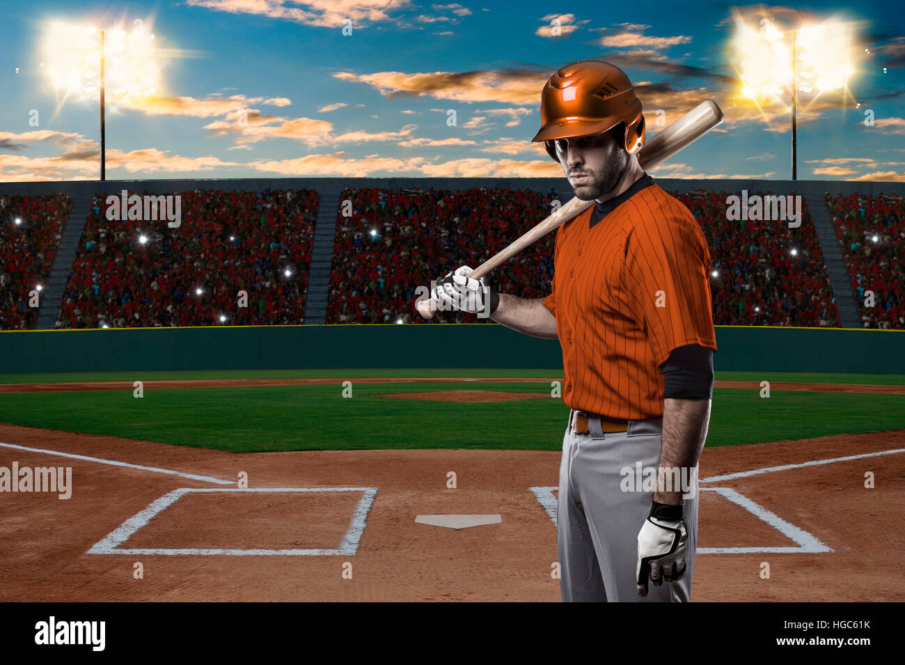 Baseball Player with a orange uniform on baseball Stadium Stock Photo ...