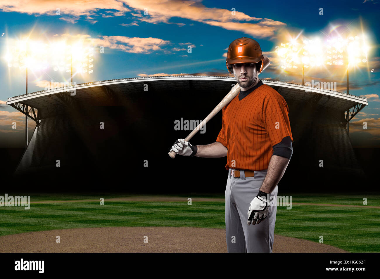 Baseball Player with a orange uniform on baseball Stadium Stock Photo ...