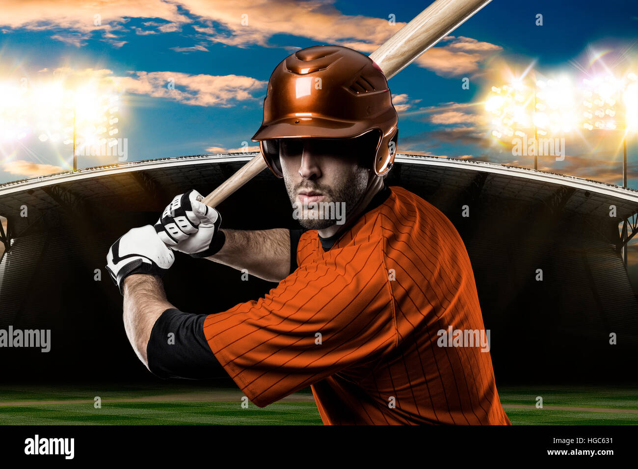 Baseball Player with a orange uniform on baseball Stadium Stock Photo ...