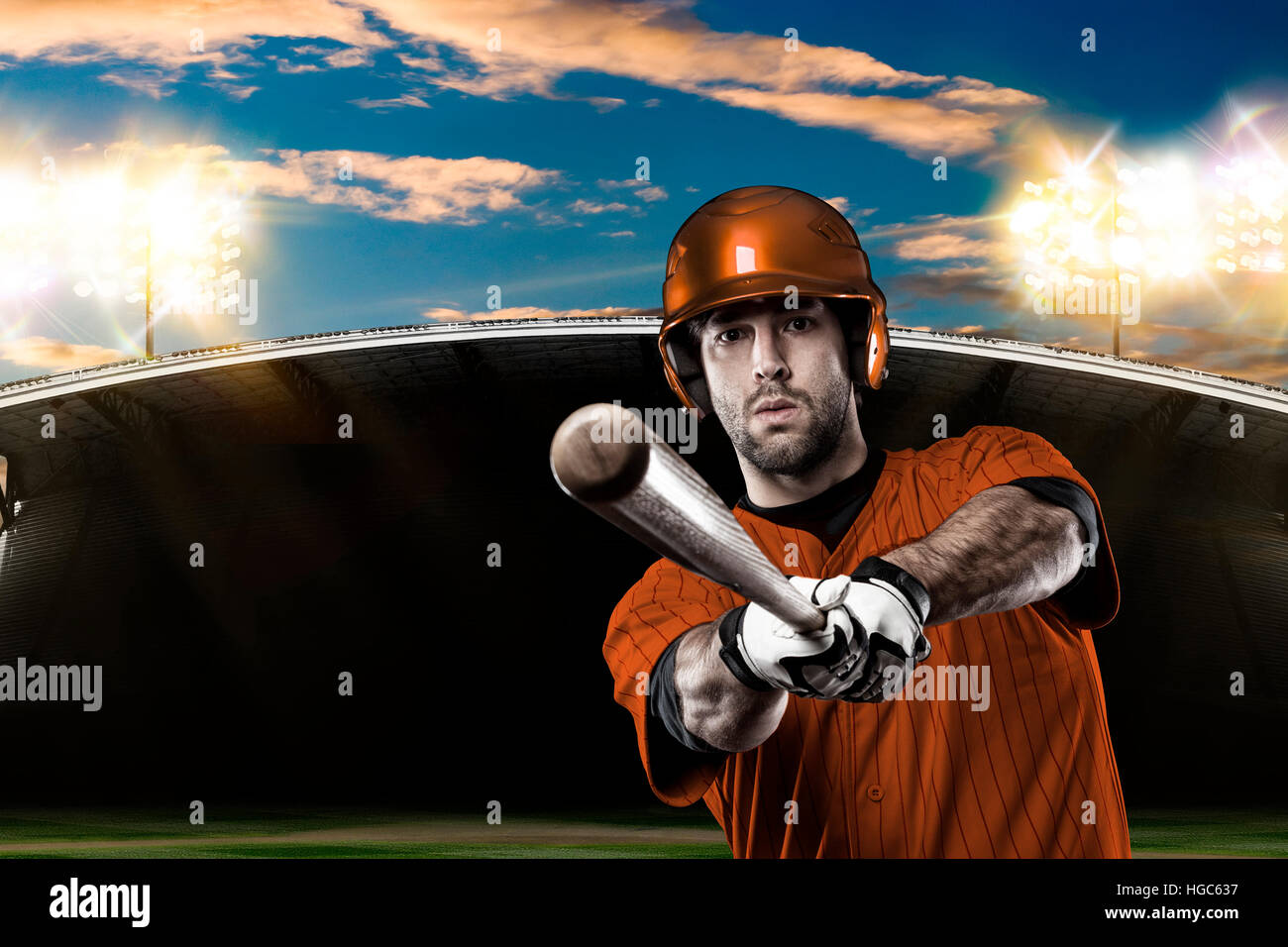 Baseball Player with a orange uniform on baseball Stadium Stock Photo ...