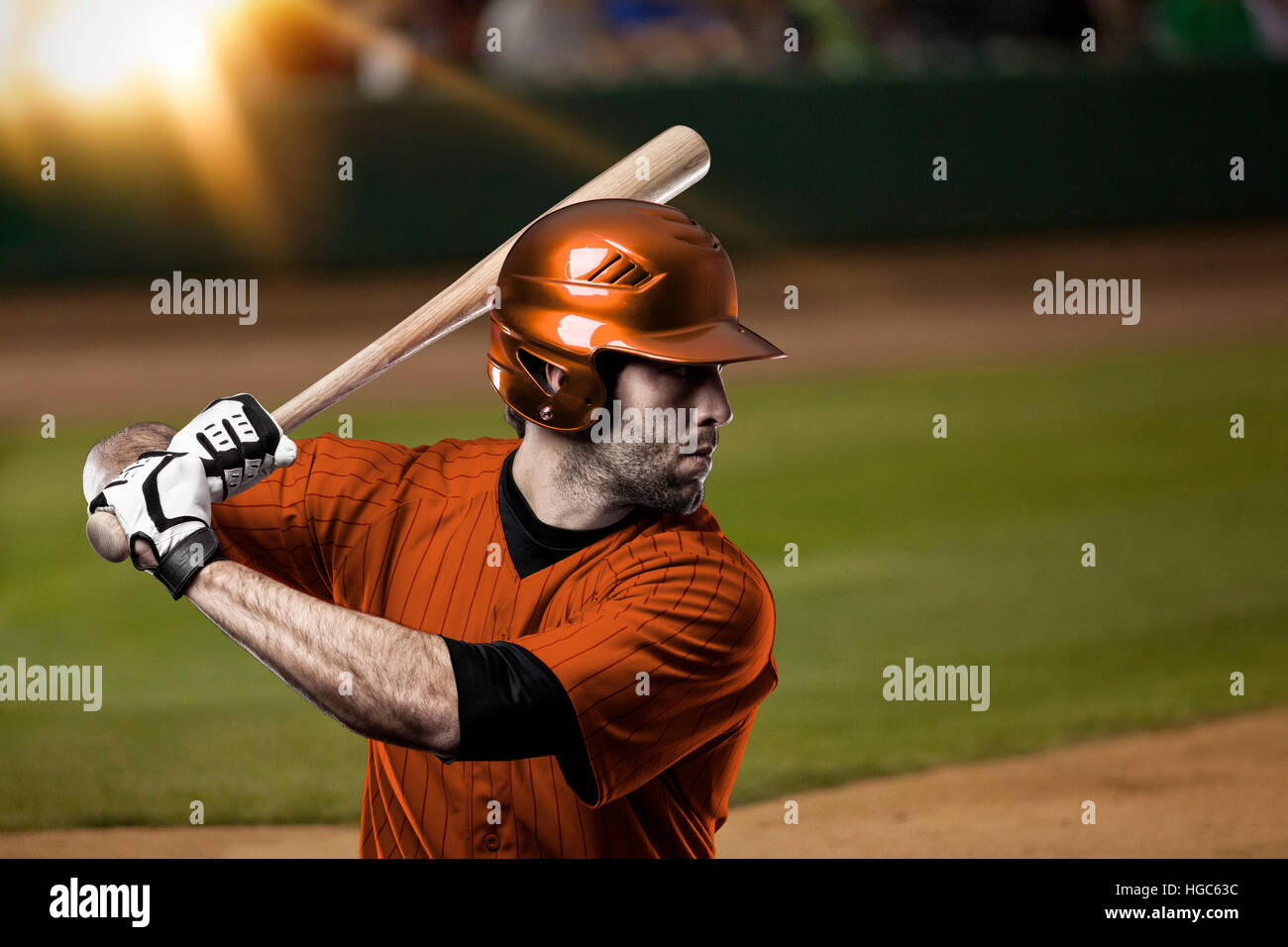 Baseball Player with a orange uniform on baseball Stadium Stock Photo ...