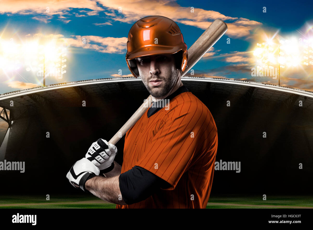 Baseball Player with a orange uniform on baseball Stadium Stock Photo ...
