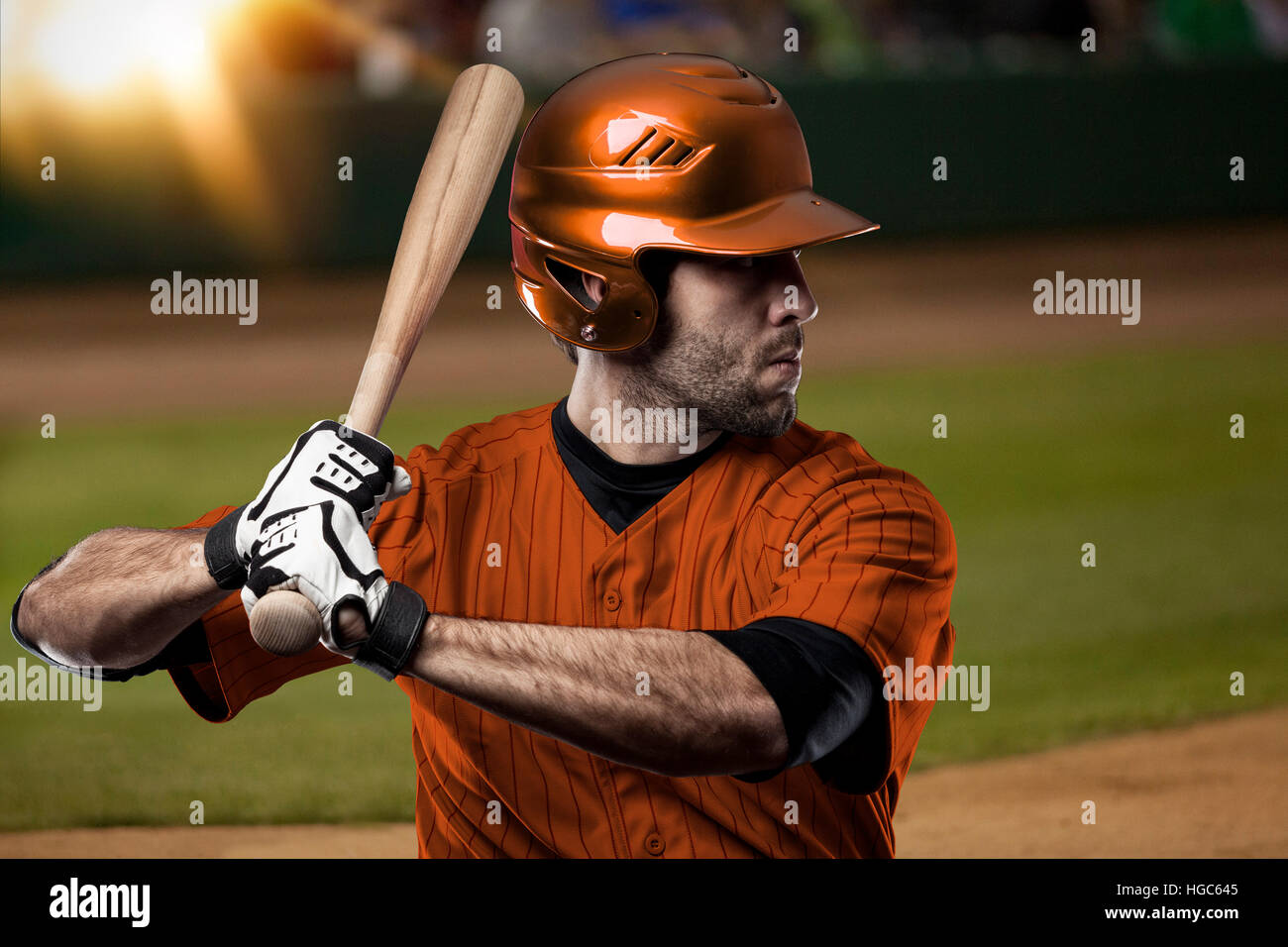 Baseball Player with a orange uniform on baseball Stadium Stock Photo ...