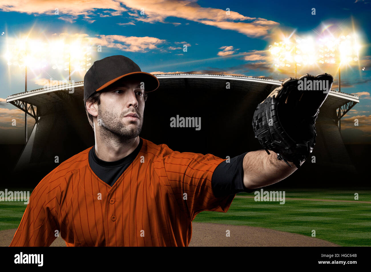 Baseball Player with a orange uniform on baseball Stadium Stock Photo ...