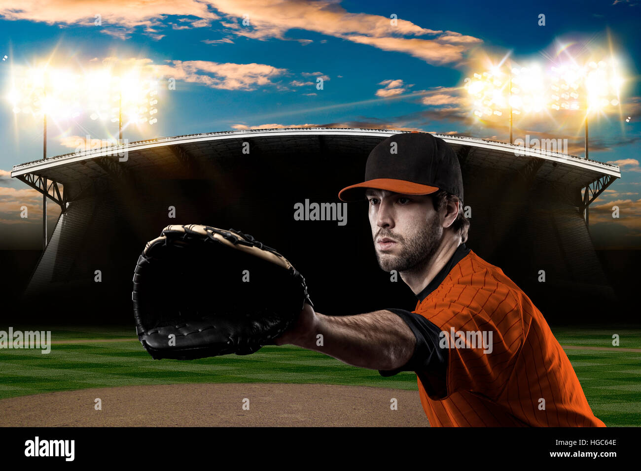 Baseball Player with a orange uniform on baseball Stadium Stock Photo ...
