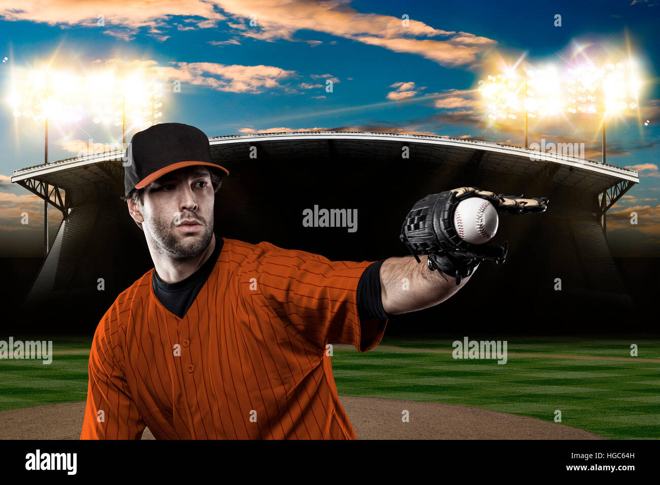Baseball Player with a orange uniform on baseball Stadium Stock Photo ...