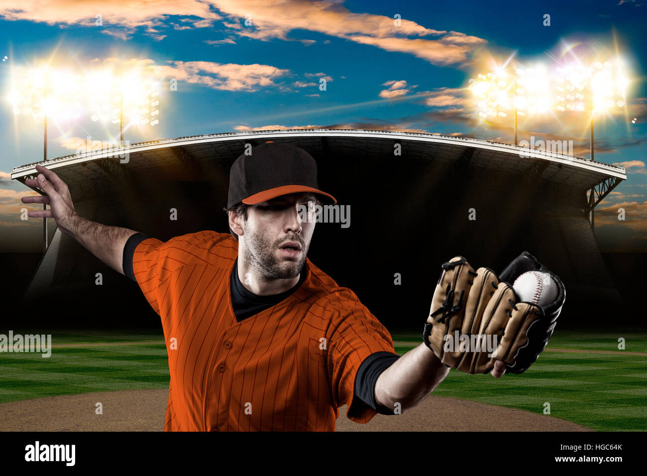 Baseball Player with a orange uniform on baseball Stadium Stock Photo ...