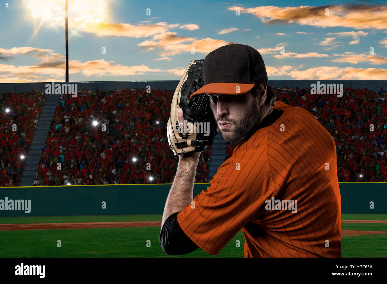 Pitcher Baseball Player with a orange uniform on baseball Stadium Stock ...