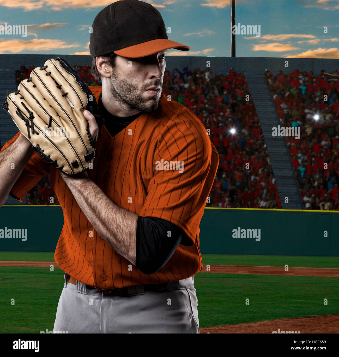Pitcher Baseball Player with a orange uniform on baseball Stadium Stock ...