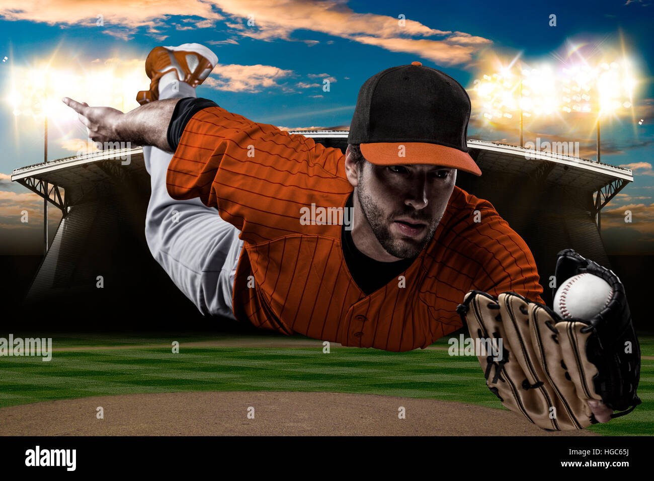 Baseball Player with a orange uniform on baseball Stadium Stock Photo ...