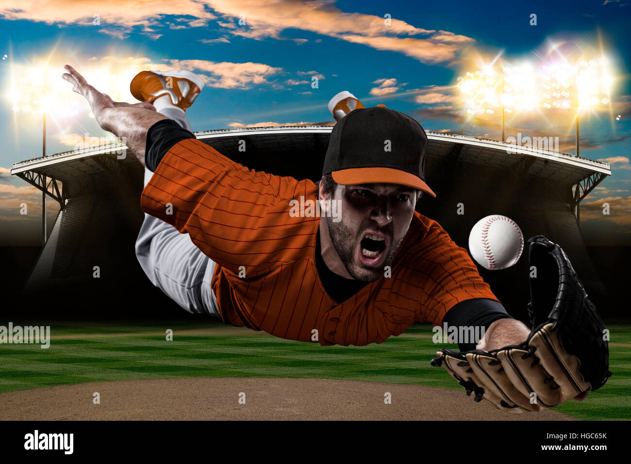 Baseball Player with a orange uniform on baseball Stadium Stock Photo ...