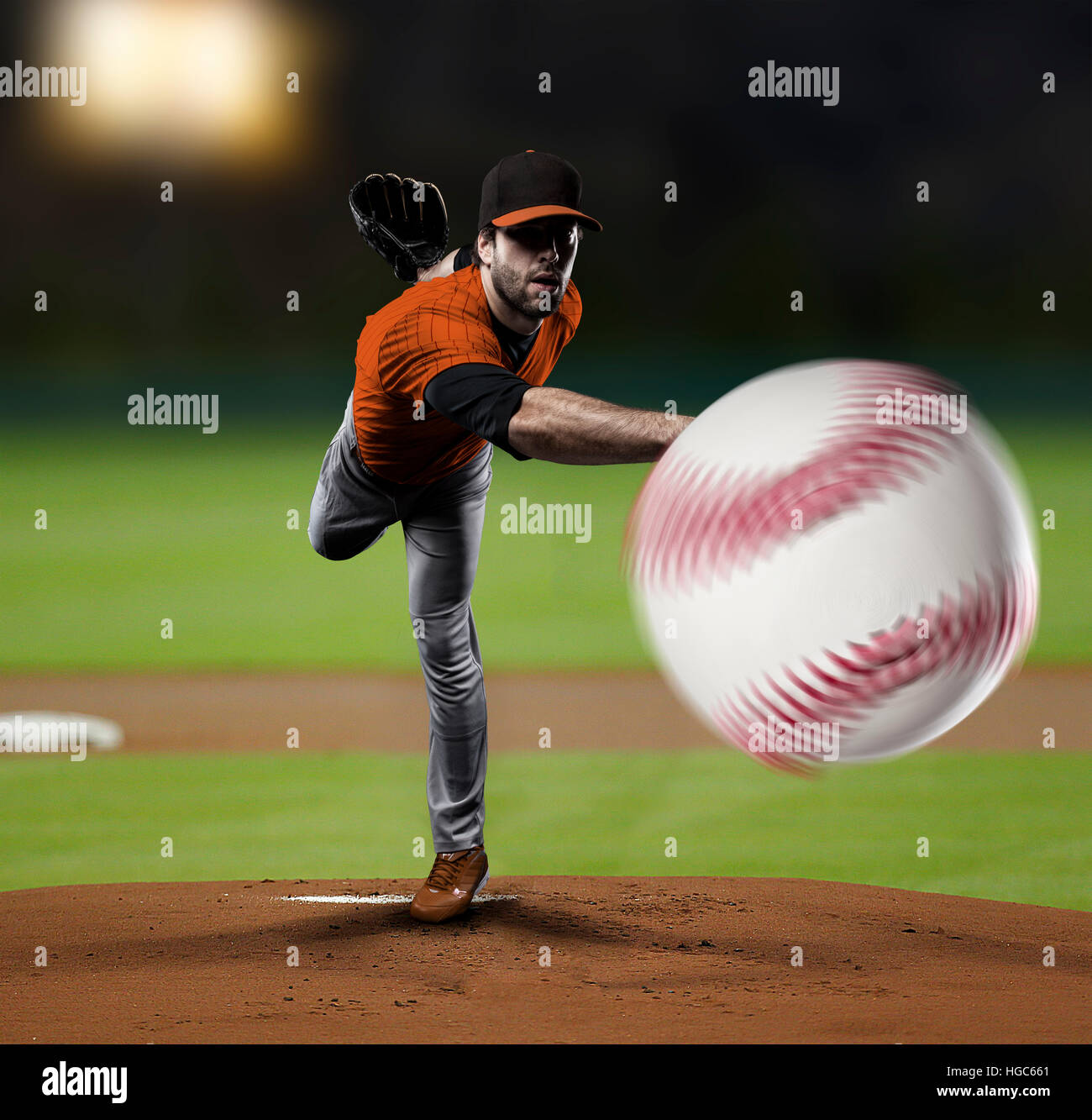 Pitcher Baseball Player with a orange uniform on baseball Stadium Stock ...