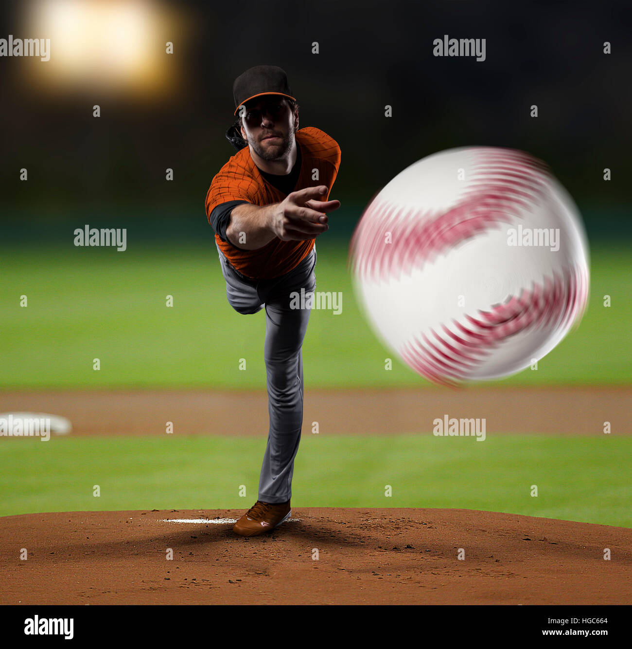 Pitcher Baseball Player with a orange uniform on baseball Stadium Stock ...