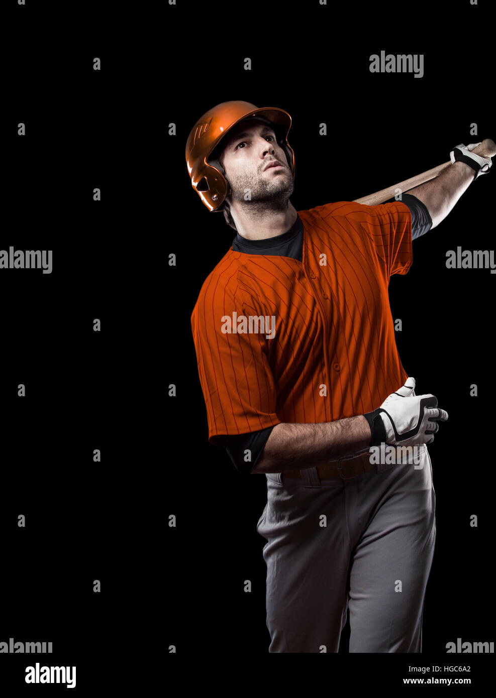 Baseball Player with a orange uniform on a black background Stock Photo ...