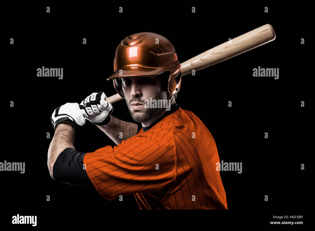 Baseball Player with a orange uniform on a black background Stock Photo ...