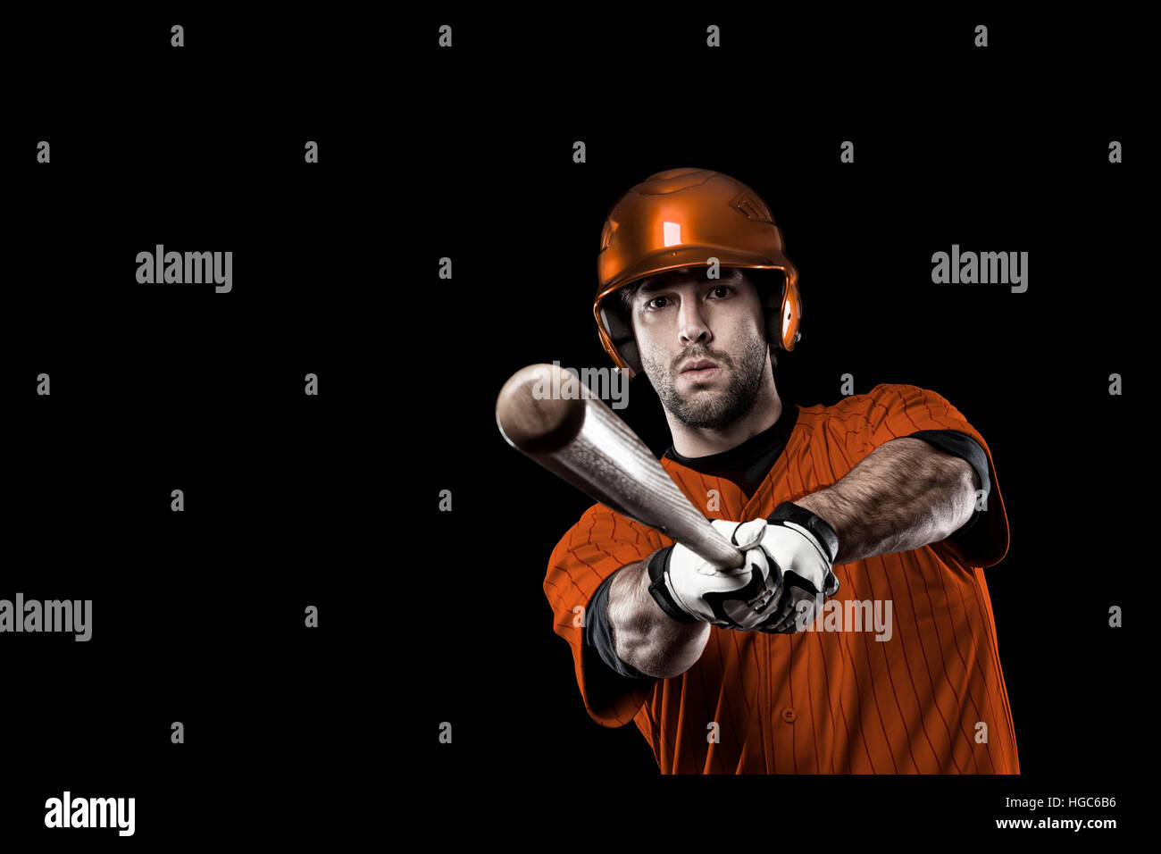 Baseball Player with a orange uniform on a black background Stock Photo ...