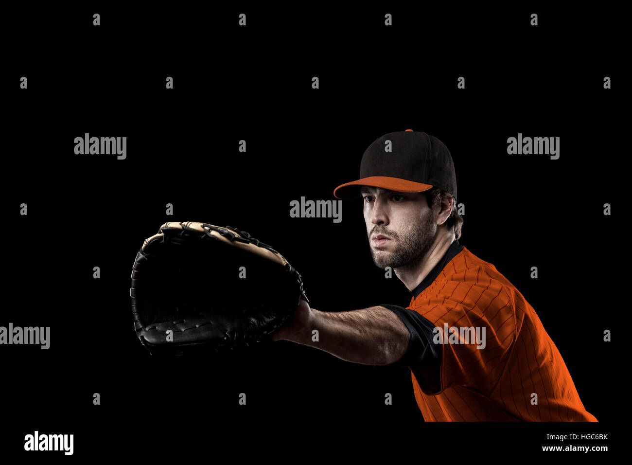 Baseball Player with a orange uniform on a black background Stock Photo ...