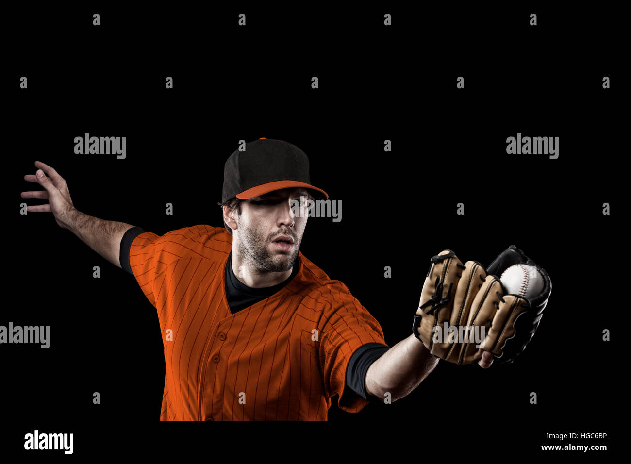 Baseball Player with a orange uniform on a black background Stock Photo ...