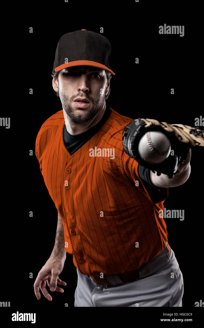 Baseball Player with a orange uniform on a black background Stock Photo ...