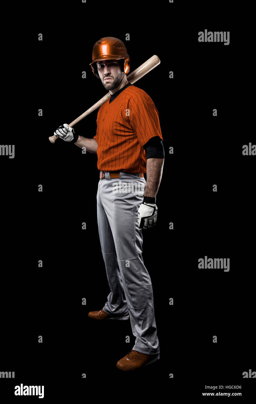 Baseball Player with a orange uniform on a black background Stock Photo ...