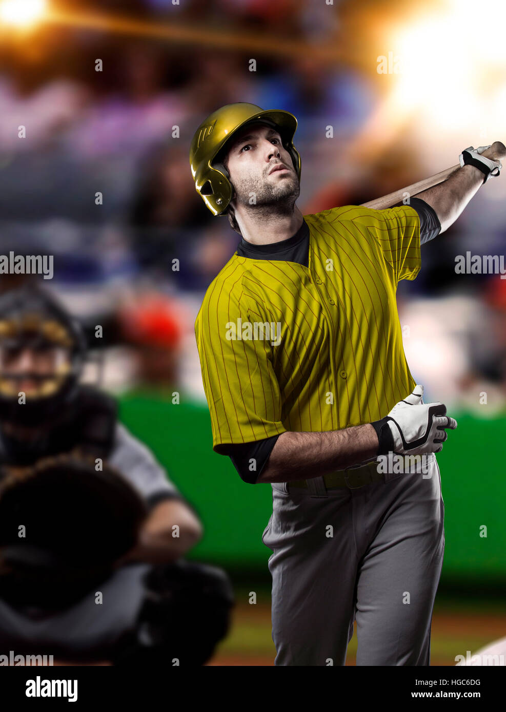 Baseball Player with a yellow uniform on baseball Stadium Stock Photo ...