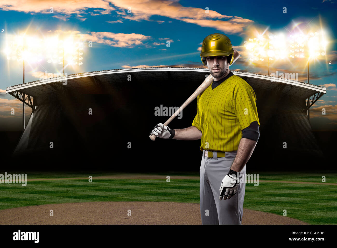 Baseball Player with a yellow uniform on baseball Stadium Stock Photo ...