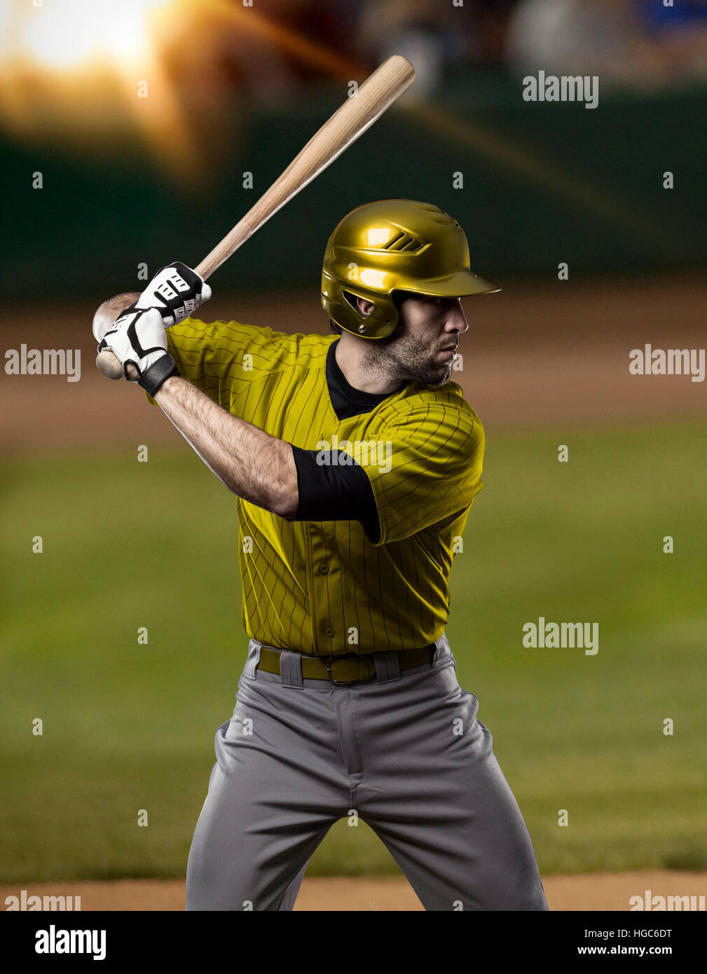 Baseball Player with a yellow uniform on baseball Stadium Stock Photo ...