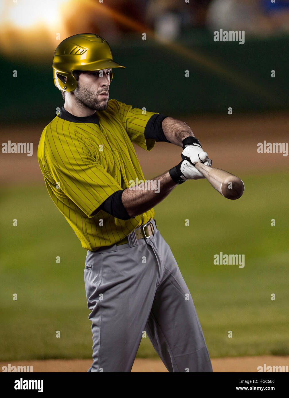 Baseball Player with a yellow uniform on baseball Stadium Stock Photo ...
